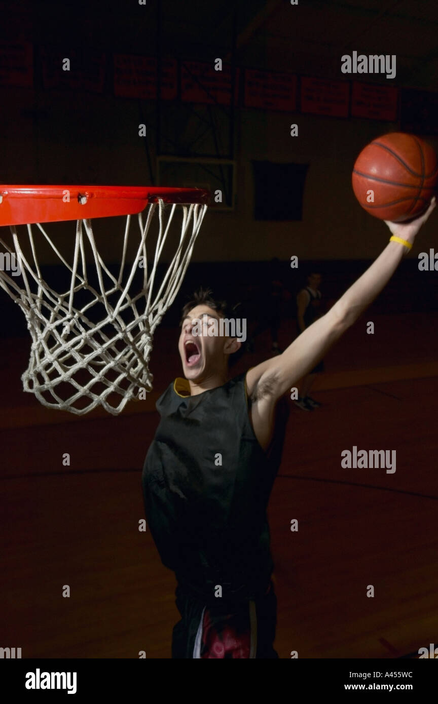 Basketball player about to slam dunk the ball Stock Photo - Alamy