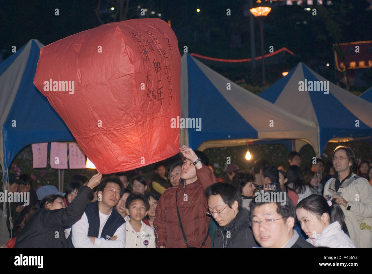 People Launching Chinese Paper Floating Lantern In Sky Heavenly Lantern ...