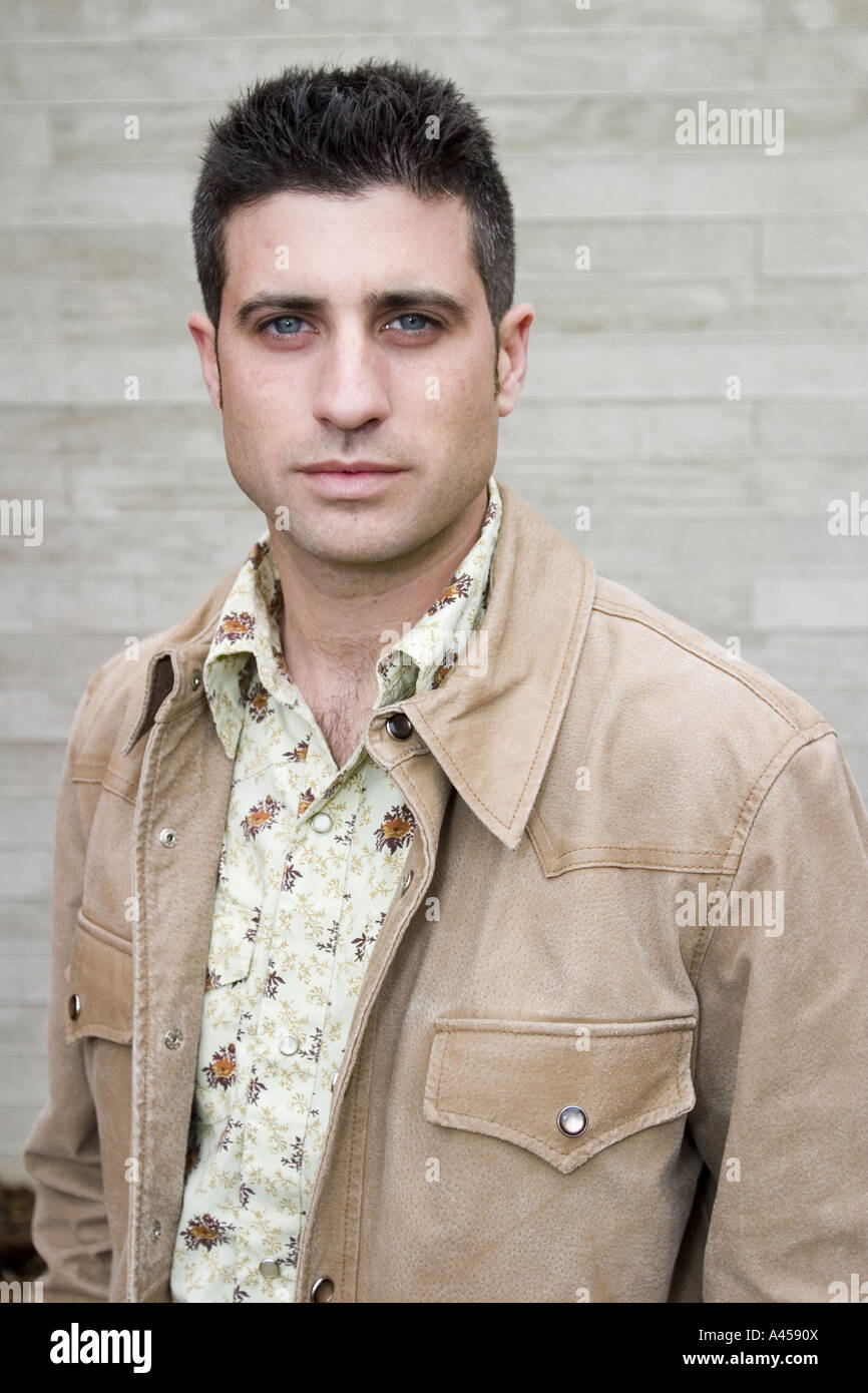 outdoor portrait of young male with wall in background Stock Photo - Alamy
