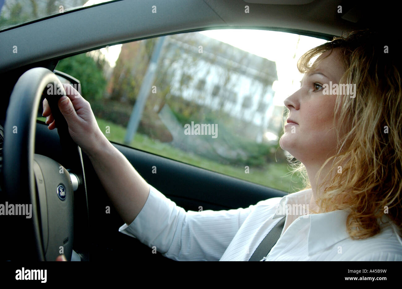 Royalty free photograph of British business woman driving to business ...
