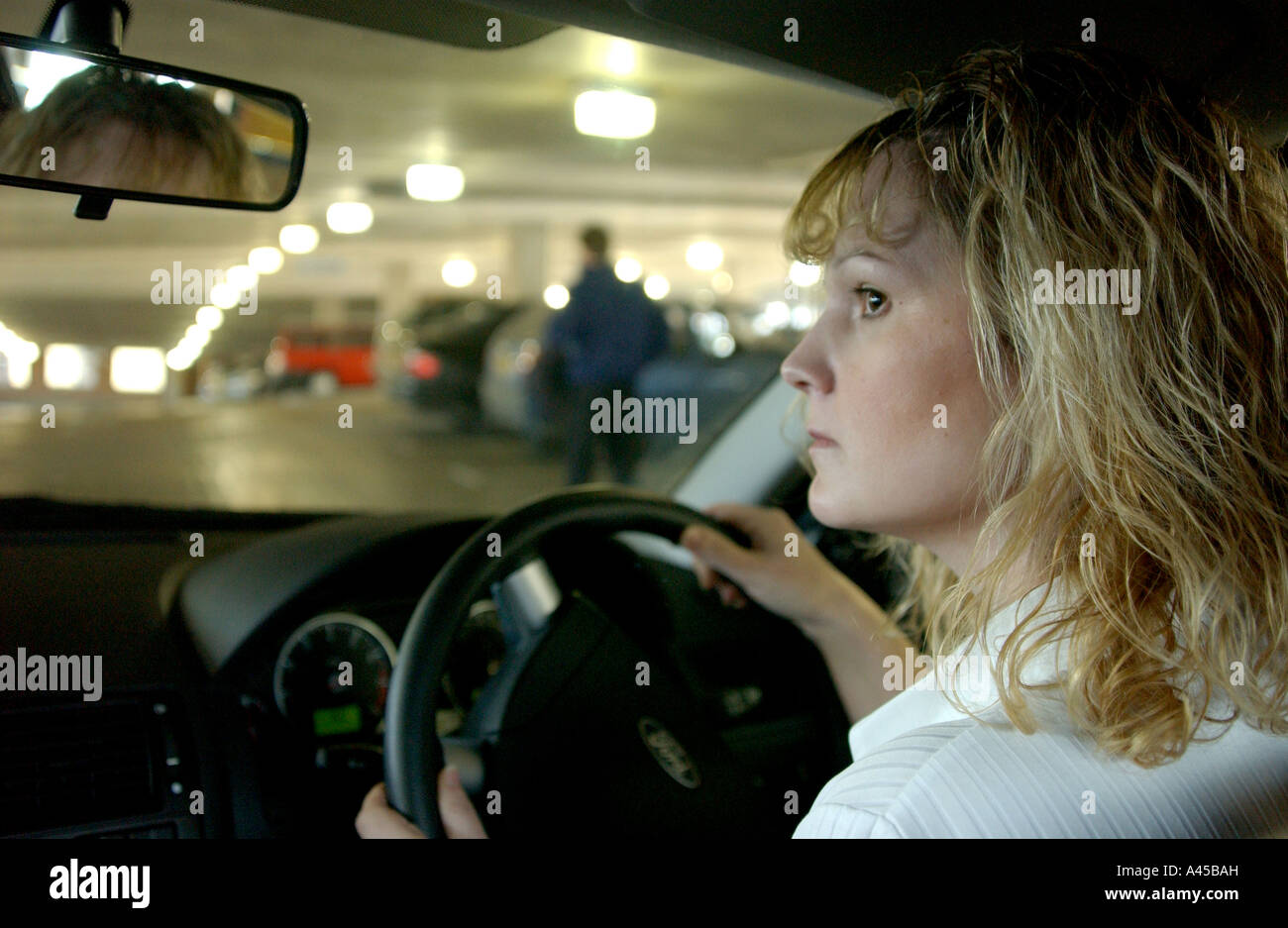 Royalty free photograph of British woman driver looking for parking ...