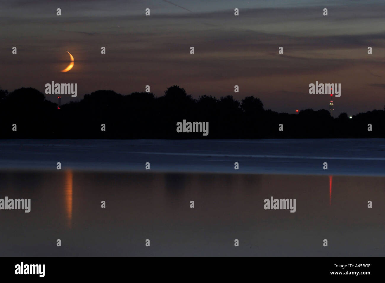 Moonshine over a lake with the lighting munich olympic tower Location ...