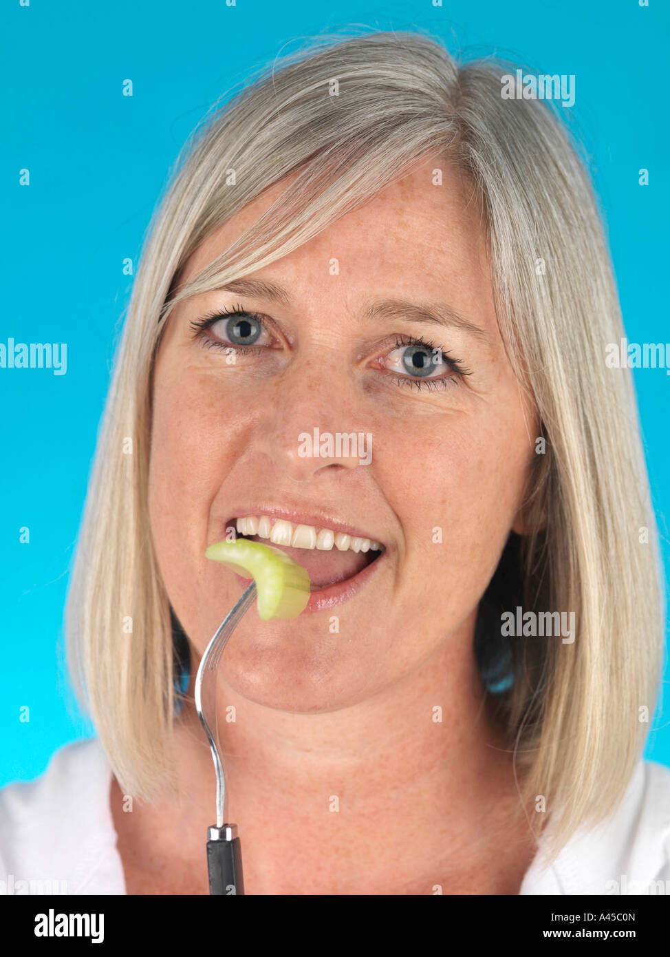 Mature Woman Eating Stick of Celery Model Released Stock Photo - Alamy