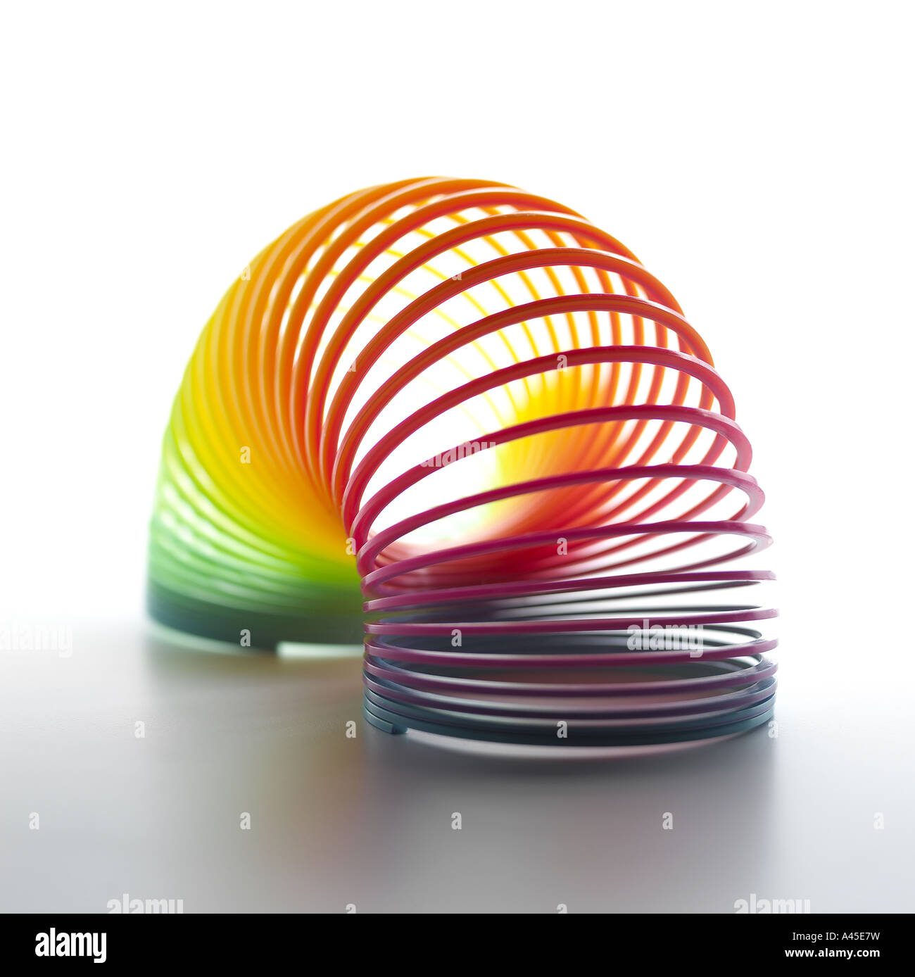 bent slinky spring childs toy bendy flexible play Stock Photo - Alamy