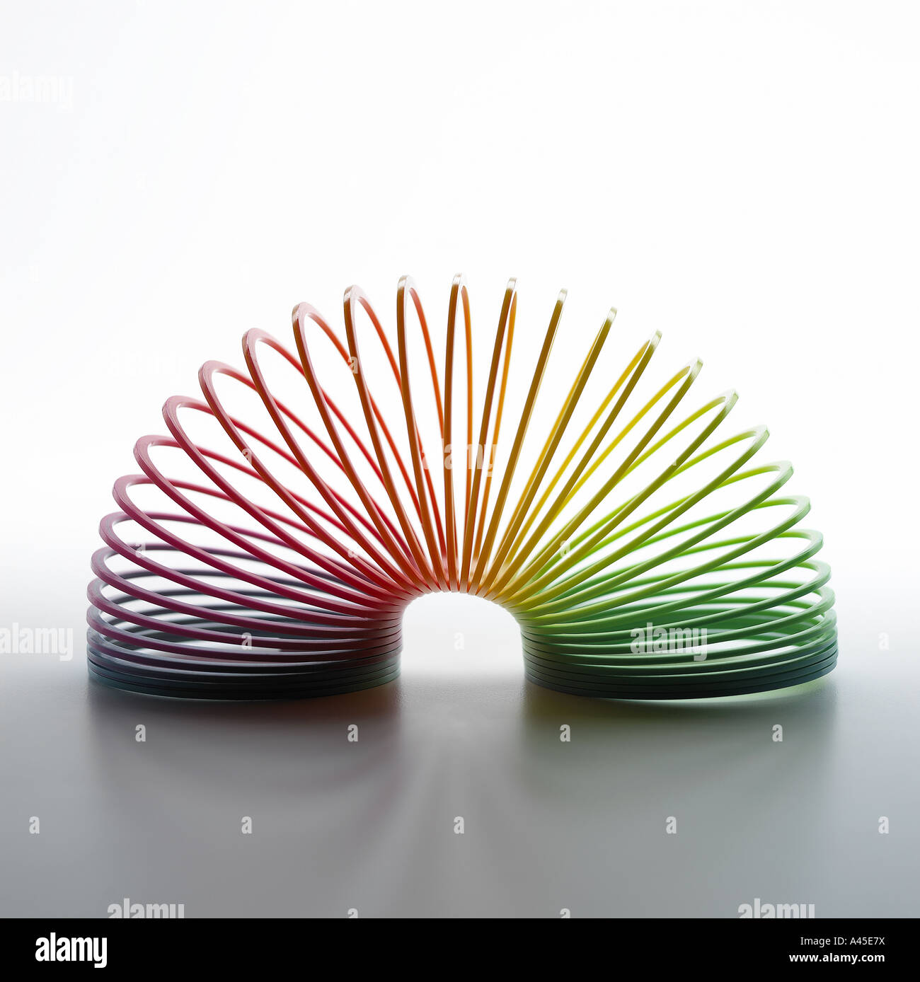 bent slinky spring childs toy bendy flexible Stock Photo - Alamy