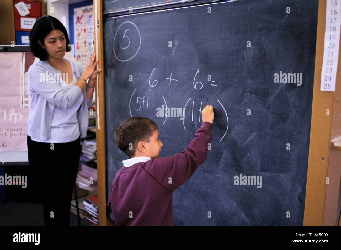 child working on a blackboard numeracy hour in year 2 class in ...