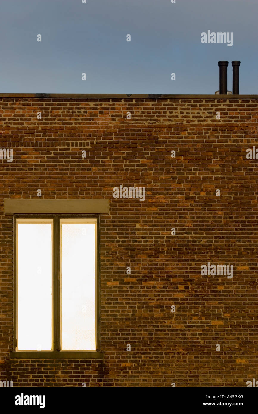 Graphic image of brick building facade with shiny reflective windows ...