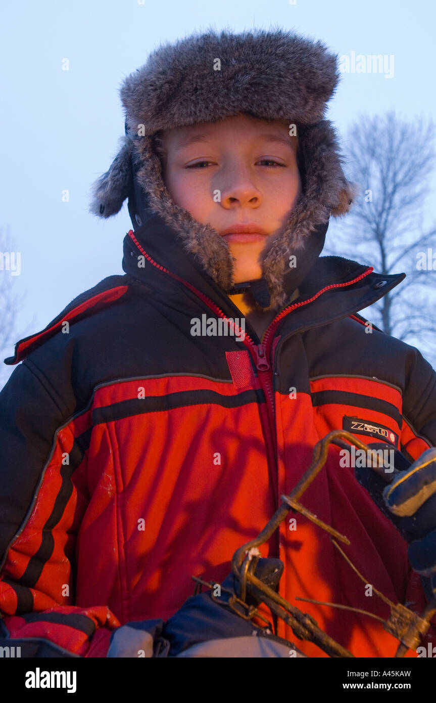 A YOUNG BOY WITH SMALL CONIBEAR TRAP IN THE EARLY MORNING NORTH CENTRAL ...