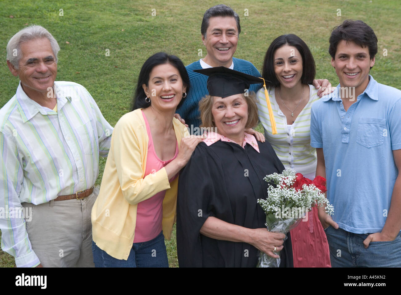 Older graduate posing with family Stock Photo - Alamy