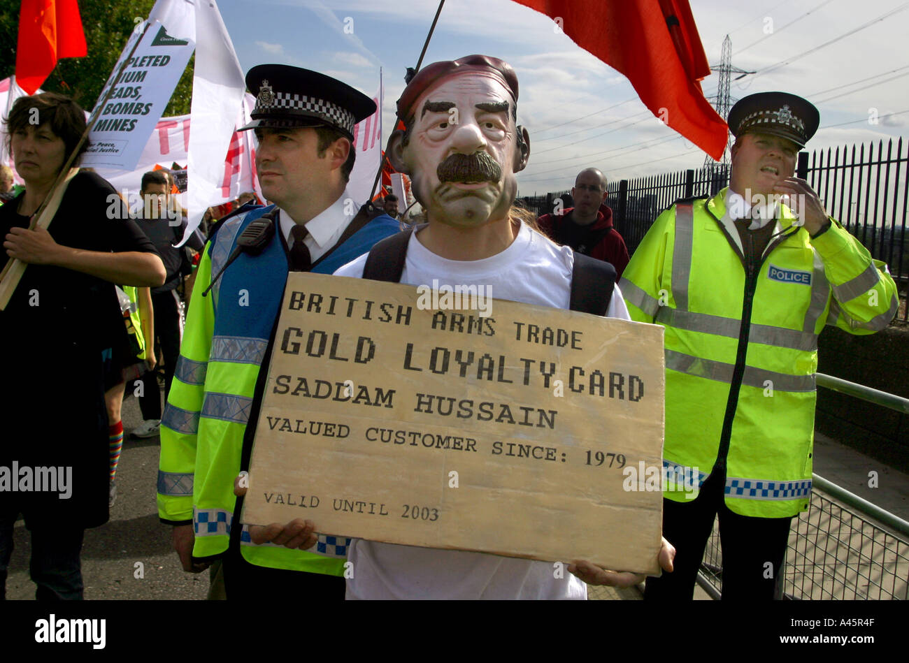 a peace protester wears a saddam hussein mask on a march against the ...