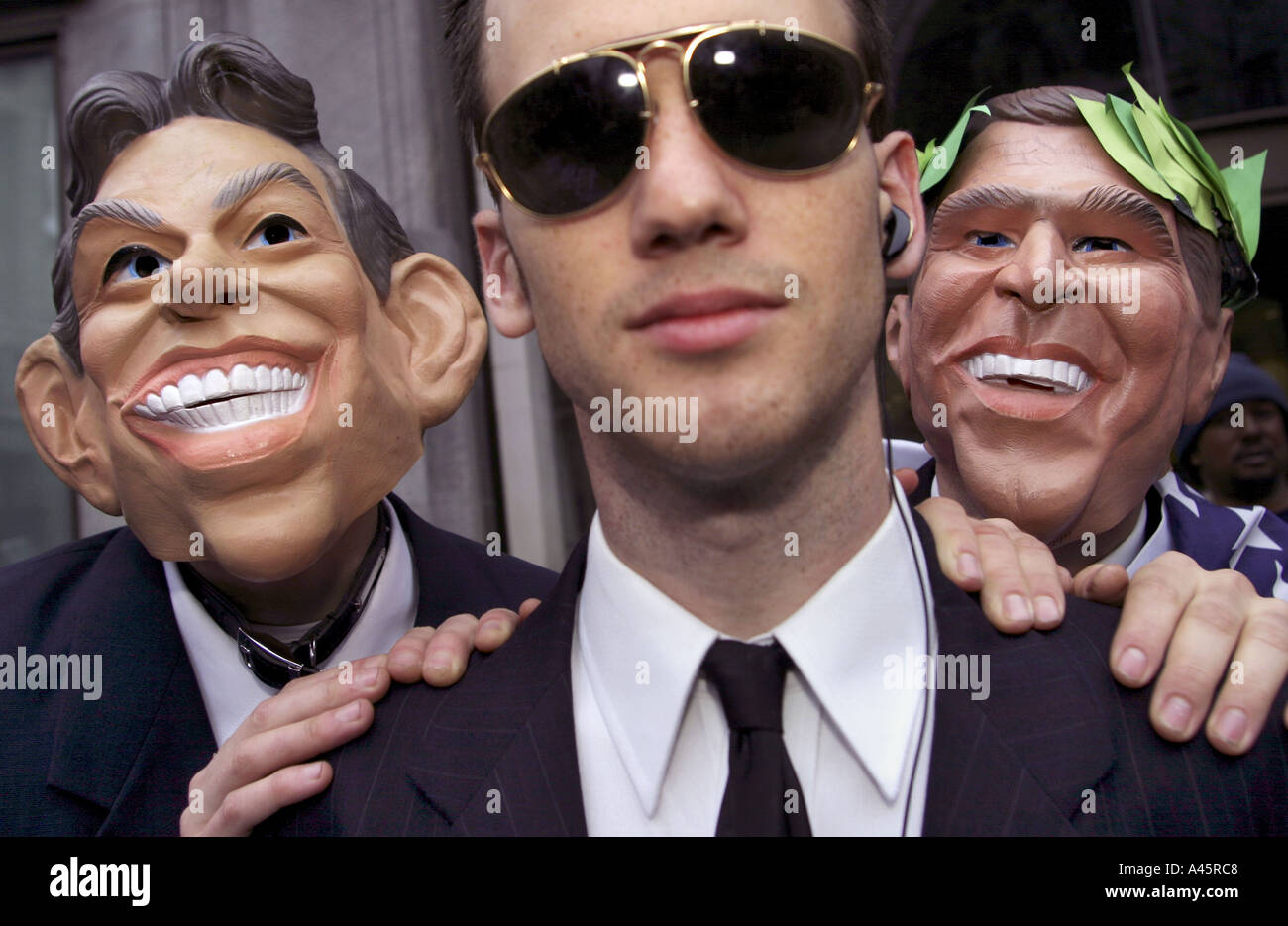 british demonstrators wear tony blair and president bush masks and look ...