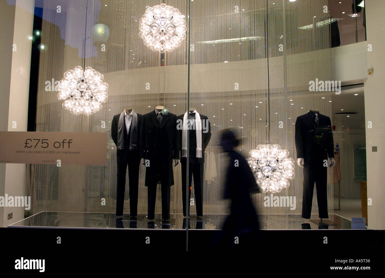 shopping in london a shopper passes a window display in regent street ...