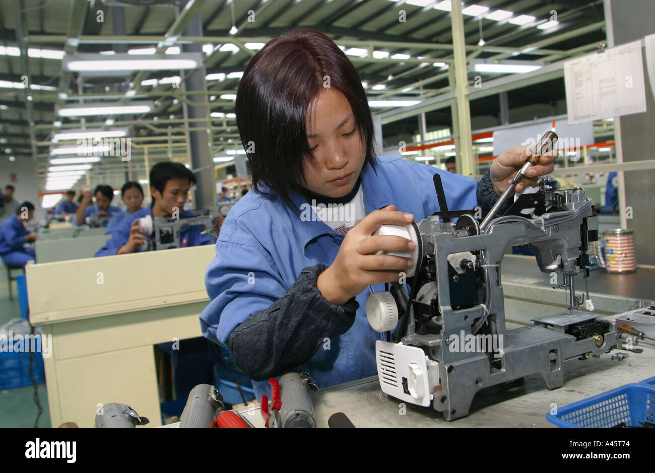 workers on the assembly line at the feiyue group sewing machine factory ...