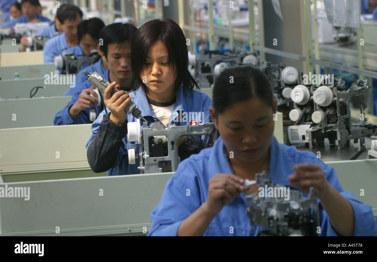 workers on the assembly line at the feiyue group sewing machine factory ...
