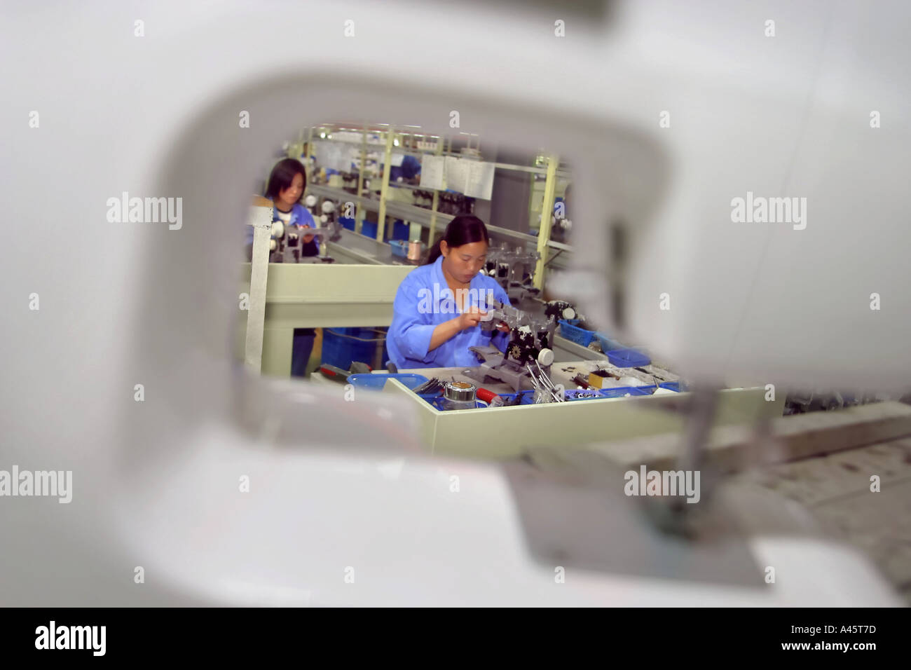 workers on the assembly line at the feiyue group sewing machine factory ...