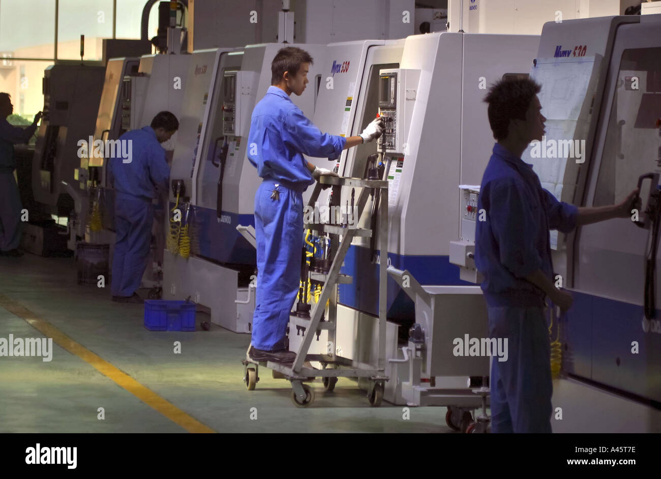 workers on the assembly line at the feiyue group sewing machine factory ...