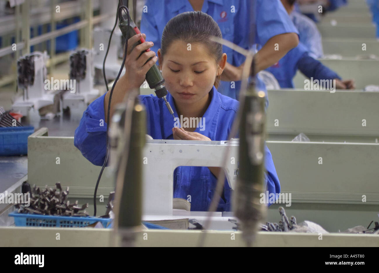 workers on the assembly line at the feiyue group sewing machine factory ...