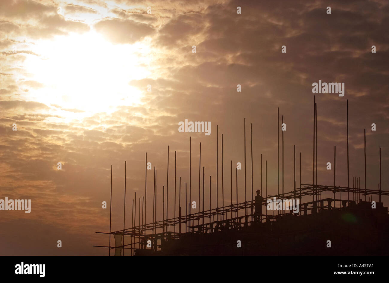 construction workers assemble scaffolding around a building in linhai ...