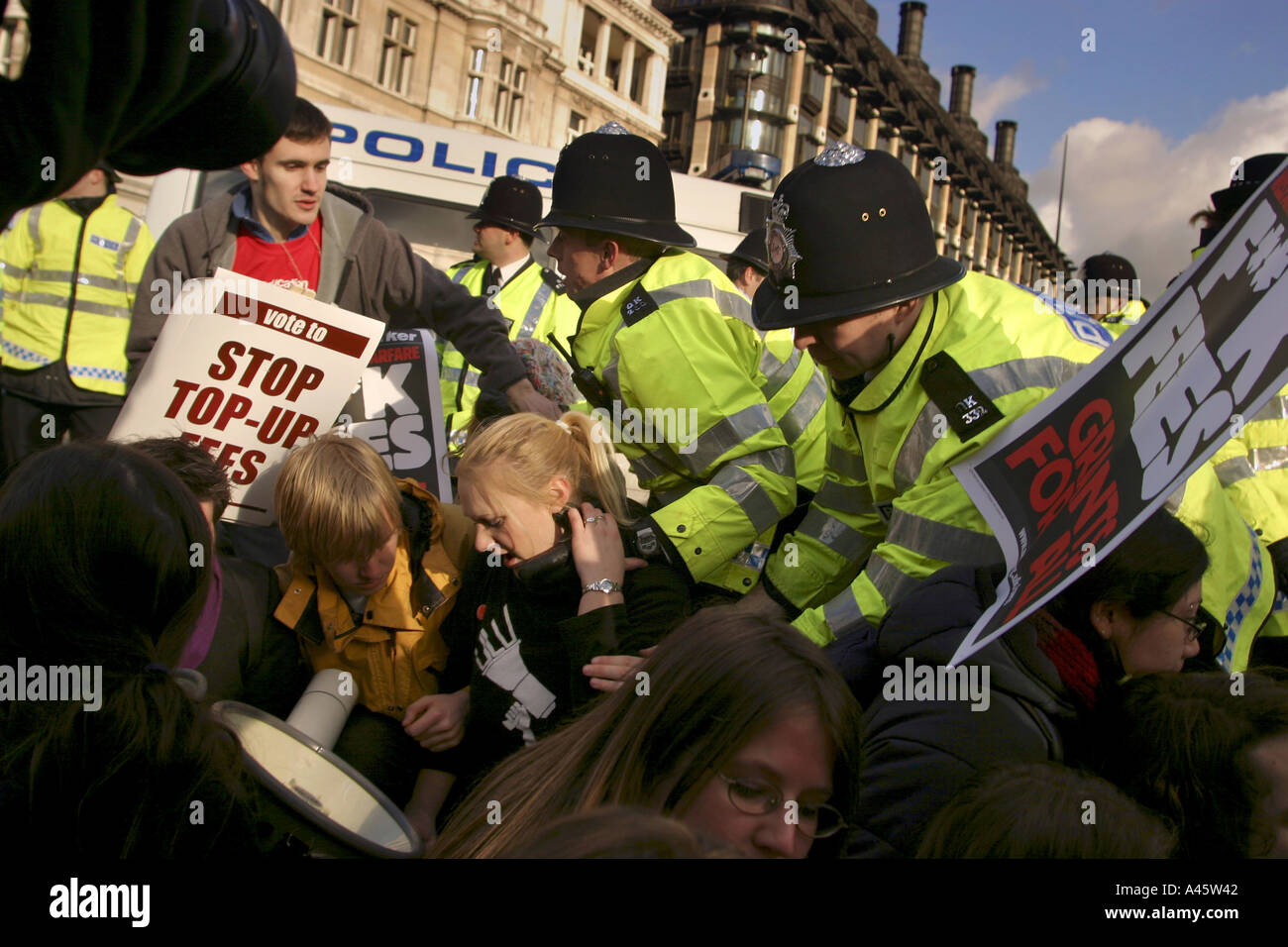 police officers drag away protesters during a demonstration by ...