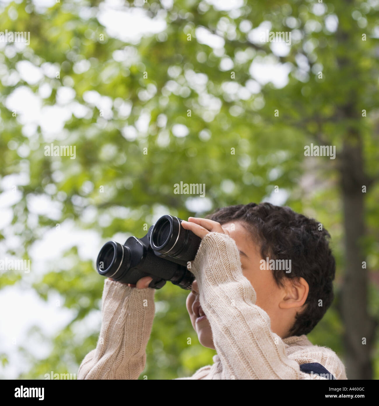 Boy using binoculars outdoors Stock Photo - Alamy