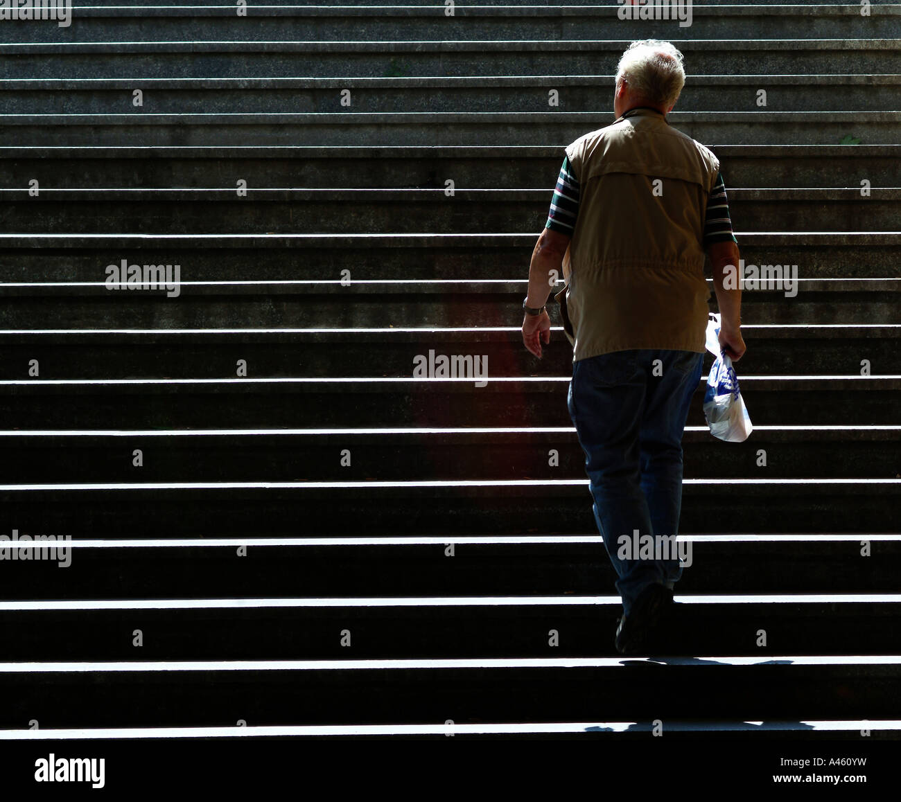 An elderly man walking up the stairs Stock Photo - Alamy