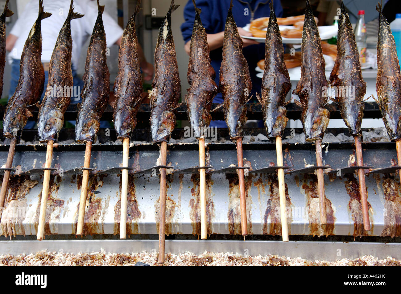 Fish on the stick beeing barbecued Stock Photo - Alamy