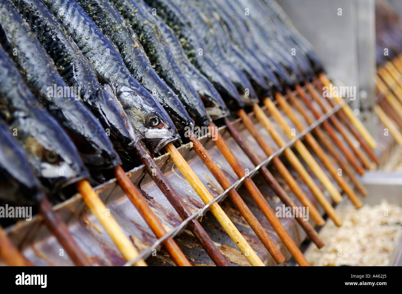 Fish on the stick beeing barbecued Stock Photo - Alamy