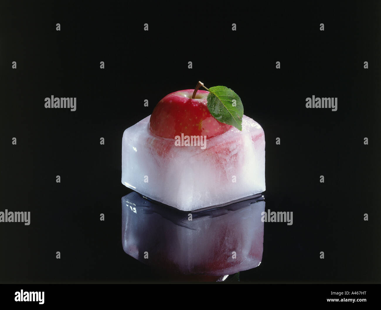An apple in an ice cube on a black background Stock Photo - Alamy