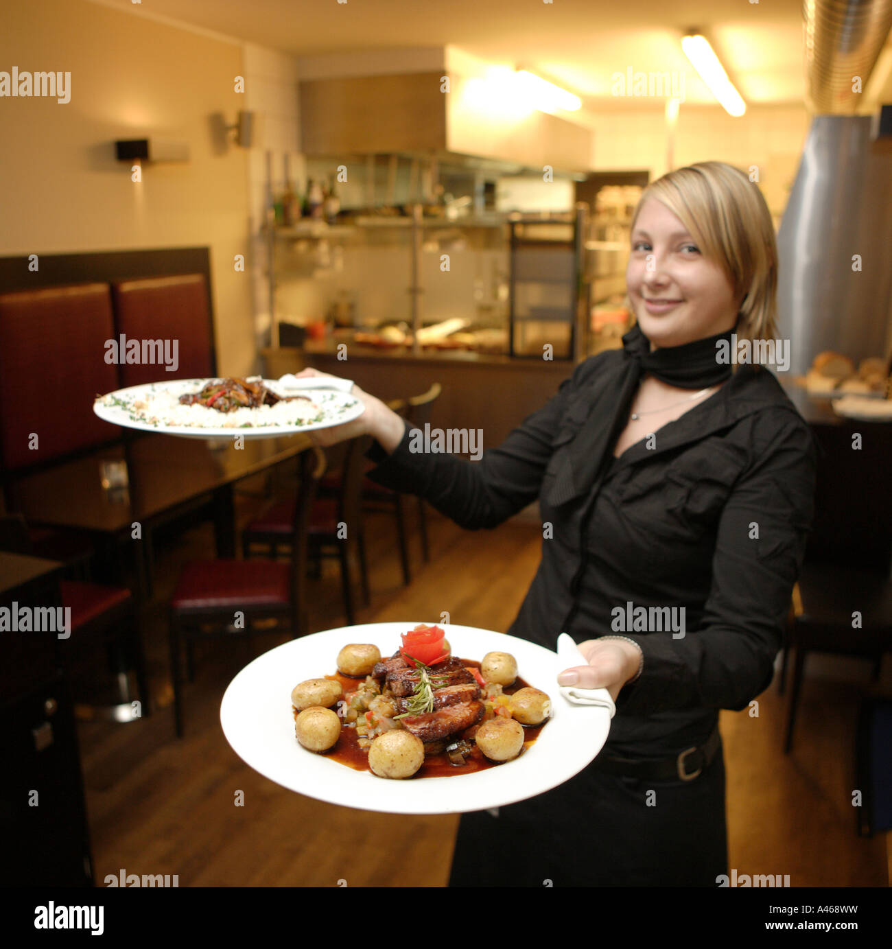 Waitress serves the meal Stock Photo - Alamy