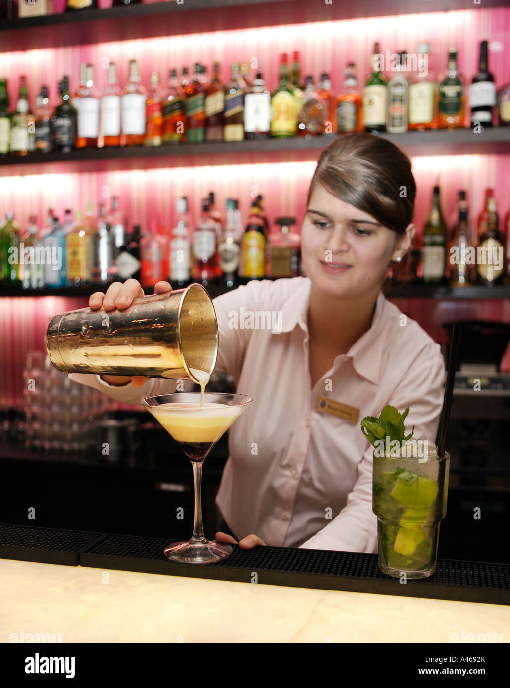 Barkeeper in the bar fifty nine in the hotel Interconti She pours her ...