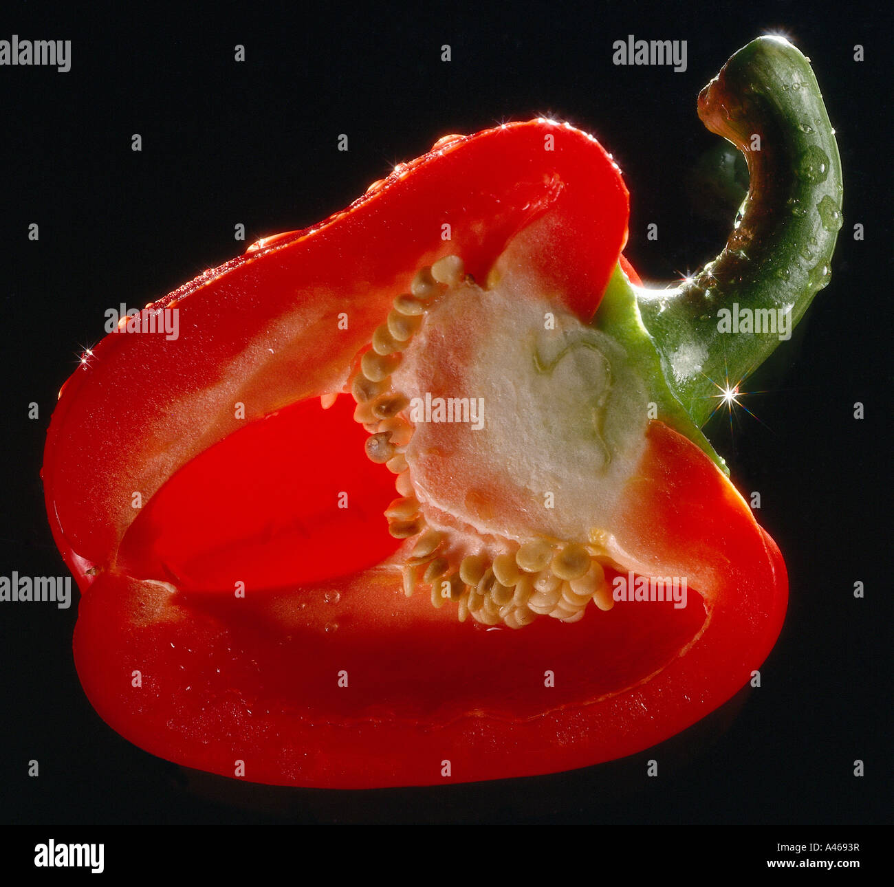 Red bell pepper cut in half on a white background Stock Photo - Alamy