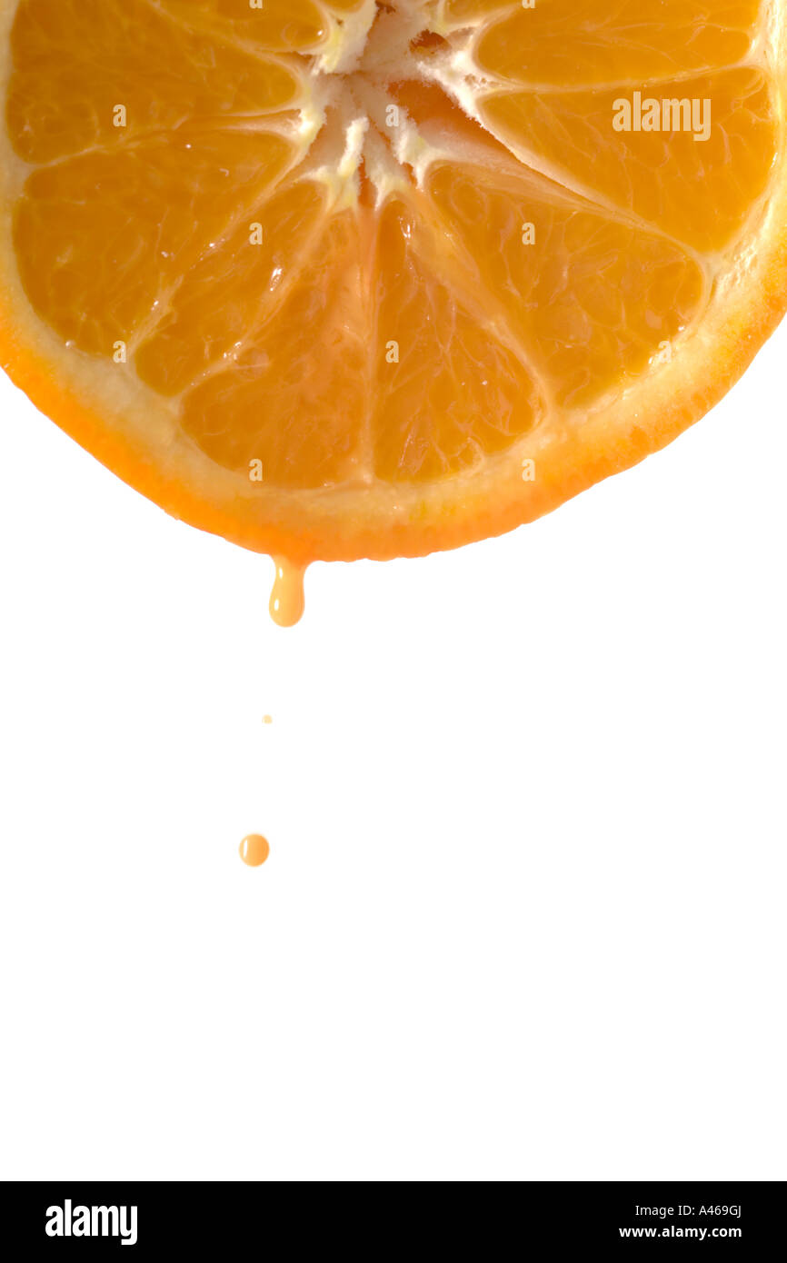 Droplets of juice falling from fresh cut orange on white background ...