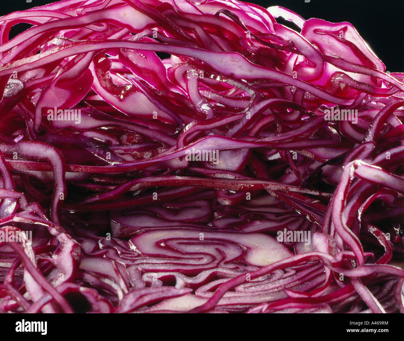 Grated red cabbage on a black background Stock Photo - Alamy