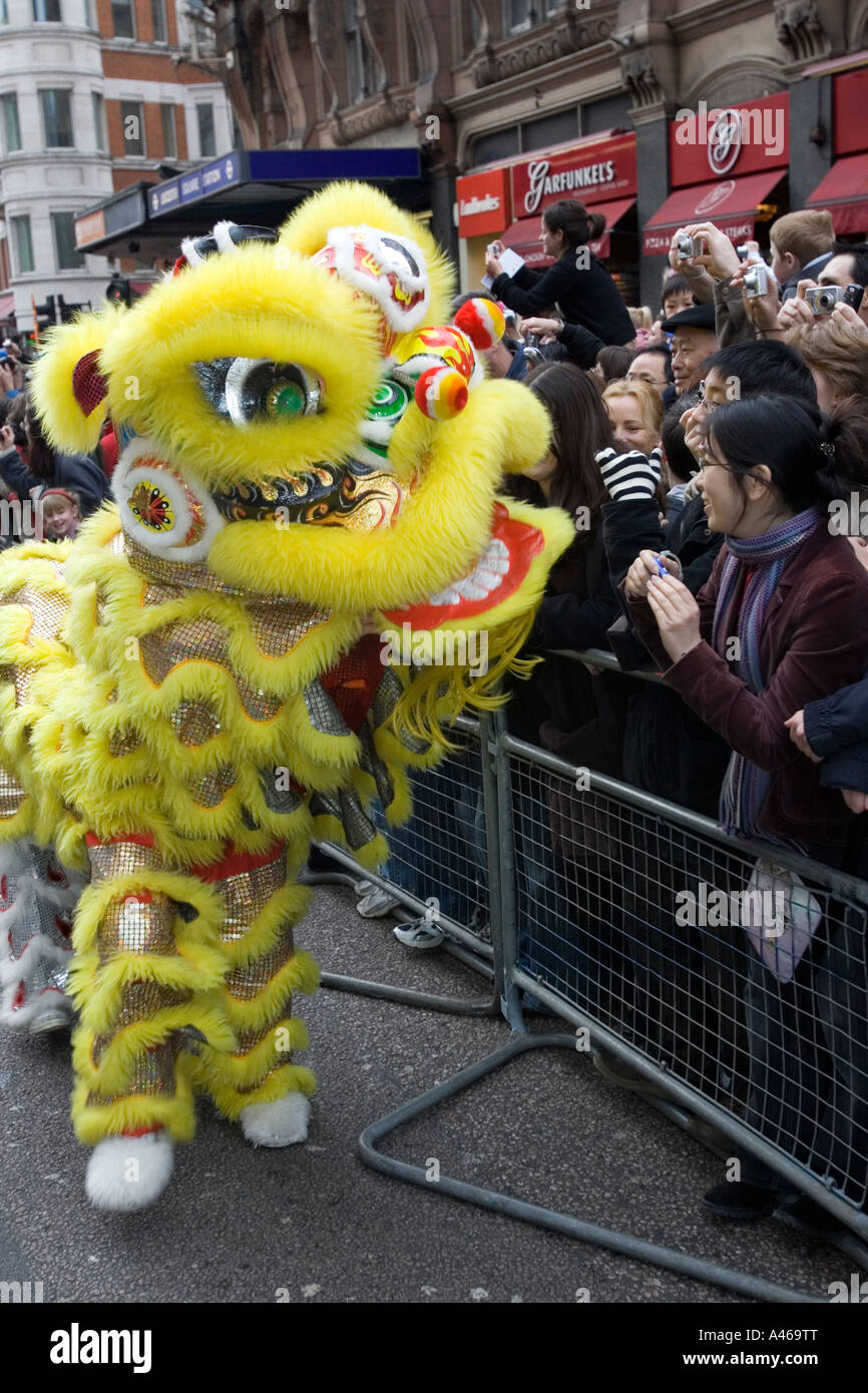 Garish yellow Chinese dragon entertains crowds during New Year parade ...