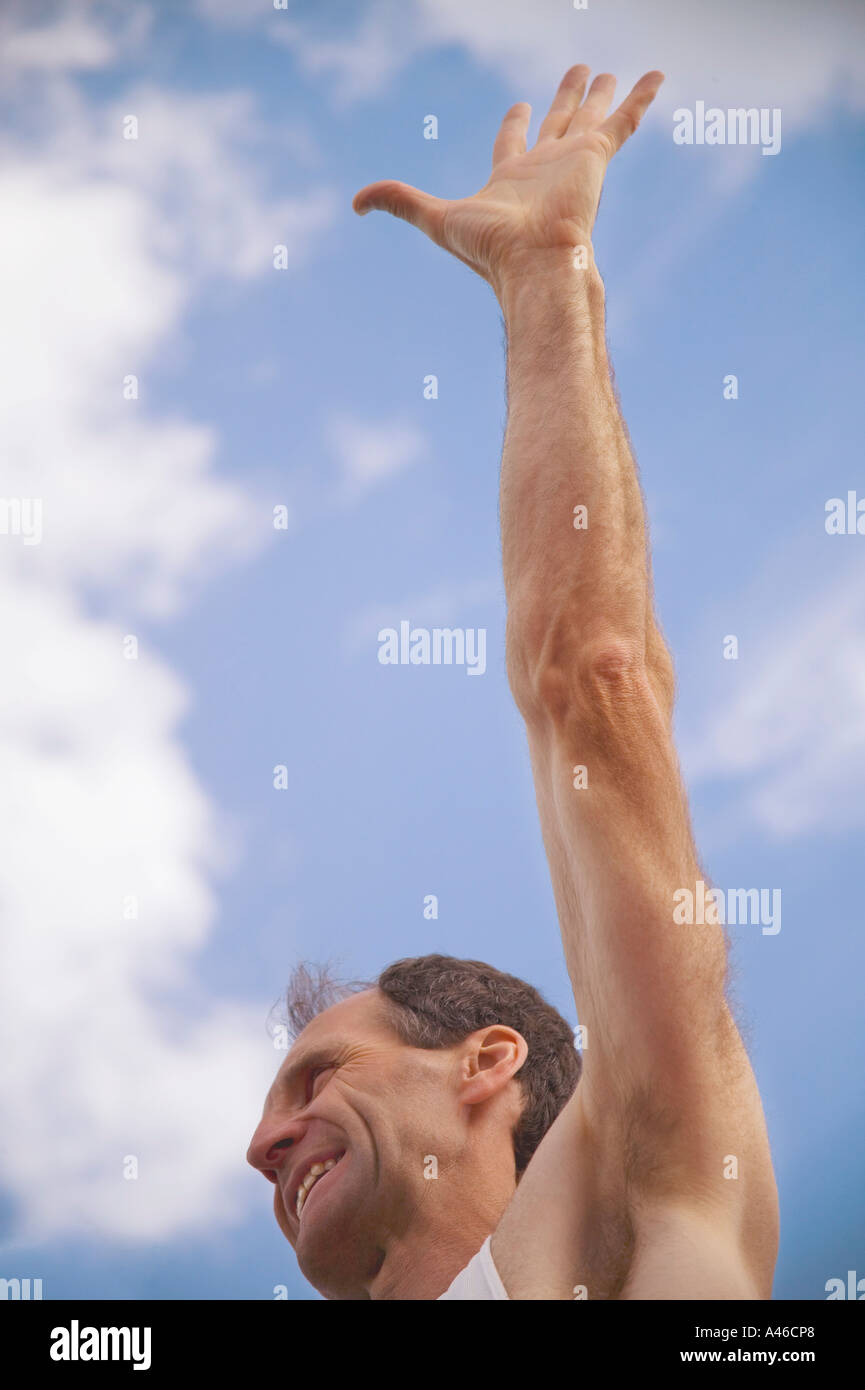 Man with arm raised Stock Photo - Alamy
