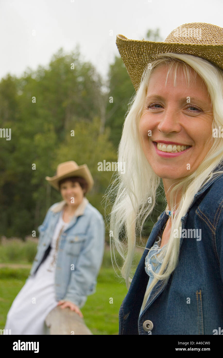 Two cowgirls on a ranch Stock Photo - Alamy