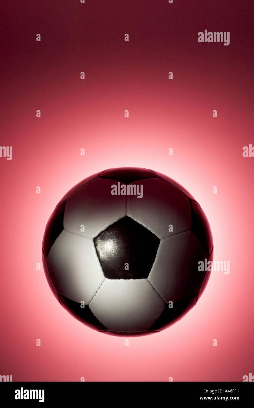 A soccer ball on red background Stock Photo - Alamy