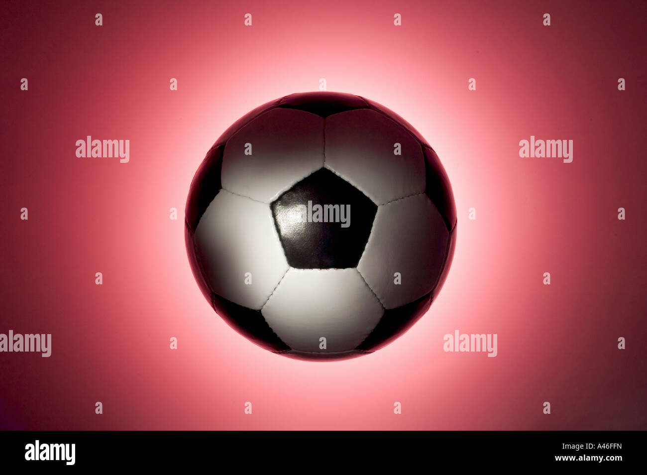 A soccer ball on red background Stock Photo - Alamy
