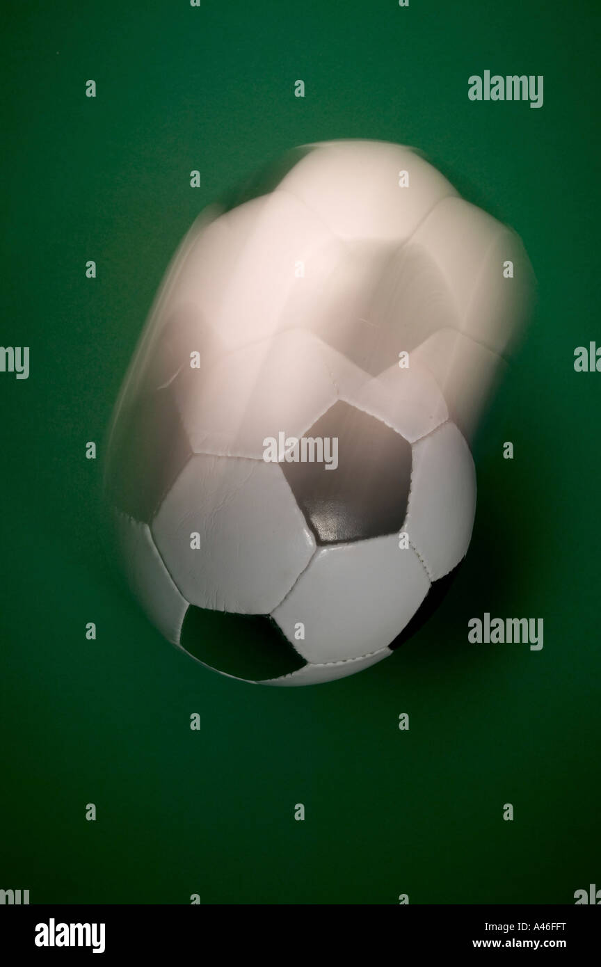 A moving soccer ball on green background Stock Photo - Alamy