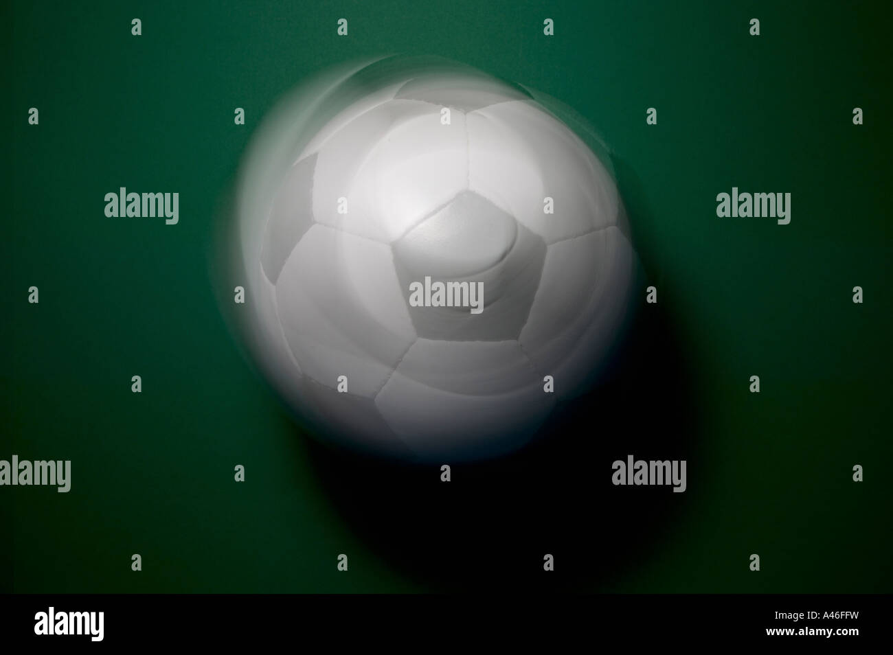 A moving soccer ball on green background Stock Photo - Alamy