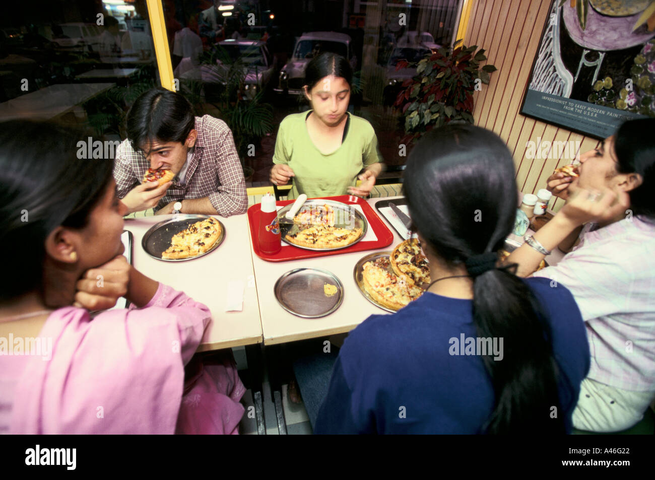 young people eating pizza in a Western style pizza restaurant in ...