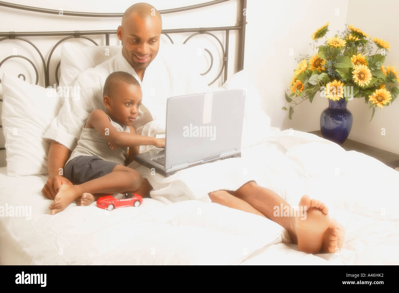 Father and son hanging out in bed Stock Photo - Alamy