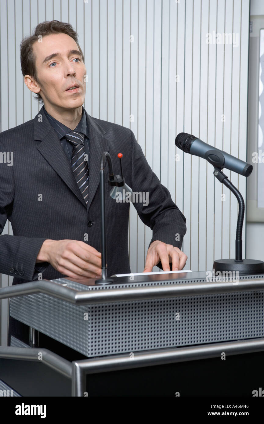 Businessman at podium Stock Photo - Alamy