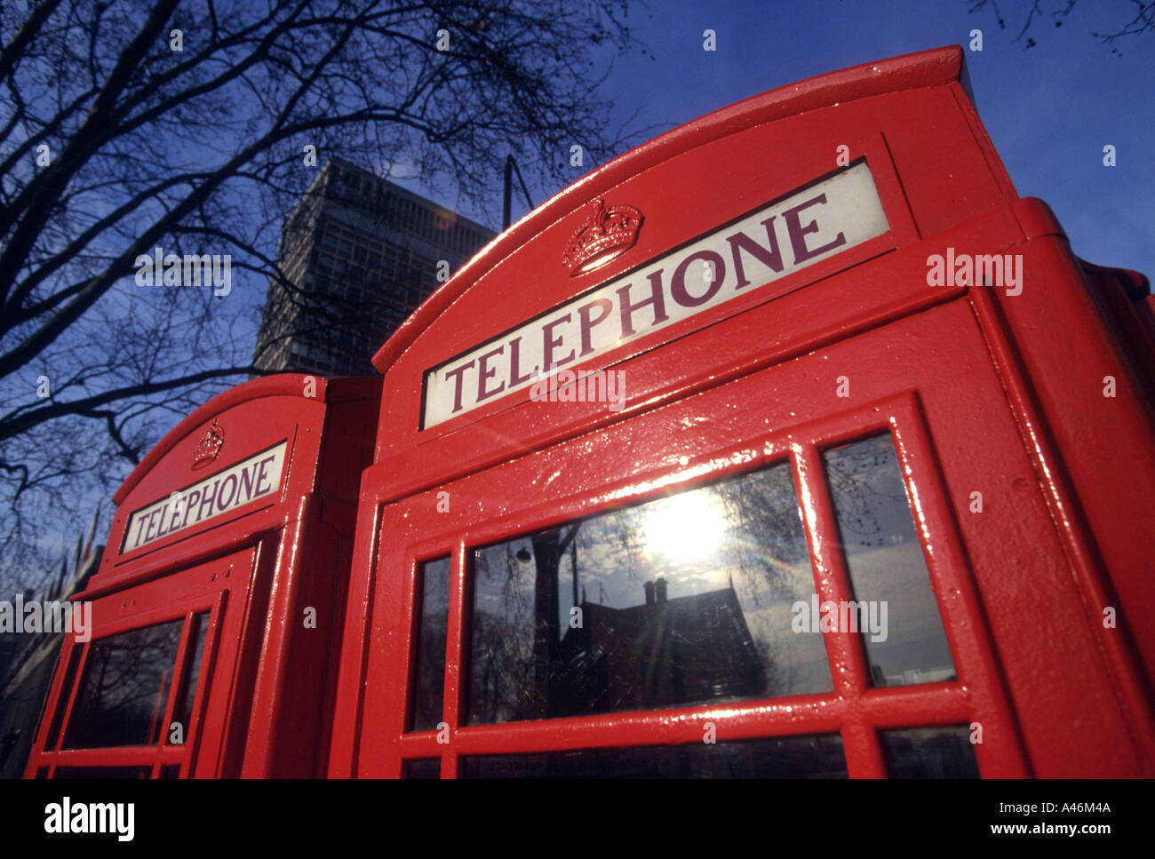 A group of traditional red telephone boxes stand on the Bayswater Road ...