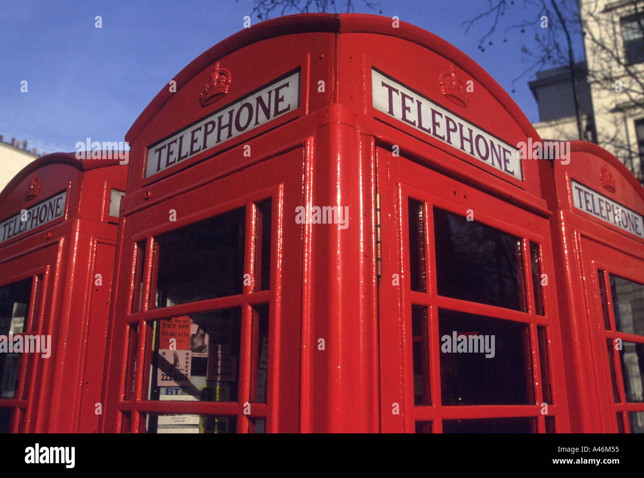 A group of traditional red telephone boxes stand on the Bayswater Road ...