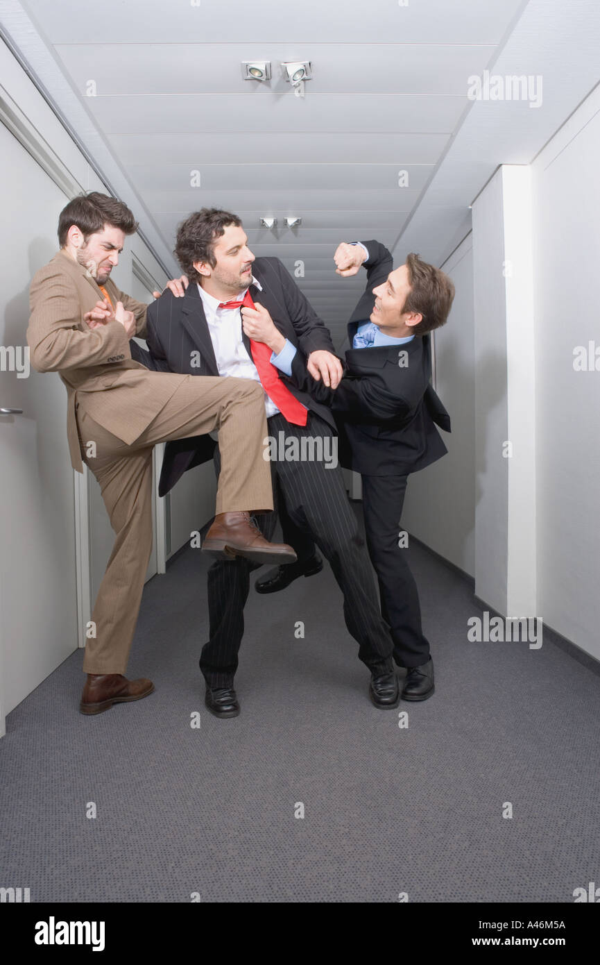 Three business people fighting hi-res stock photography and images - Alamy