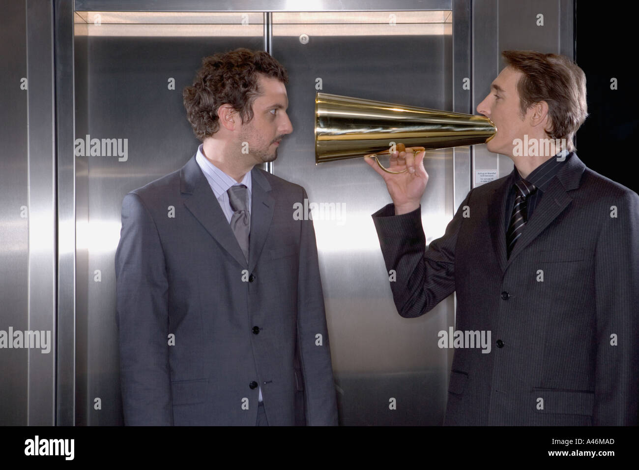 Businessman using a megaphone Stock Photo - Alamy