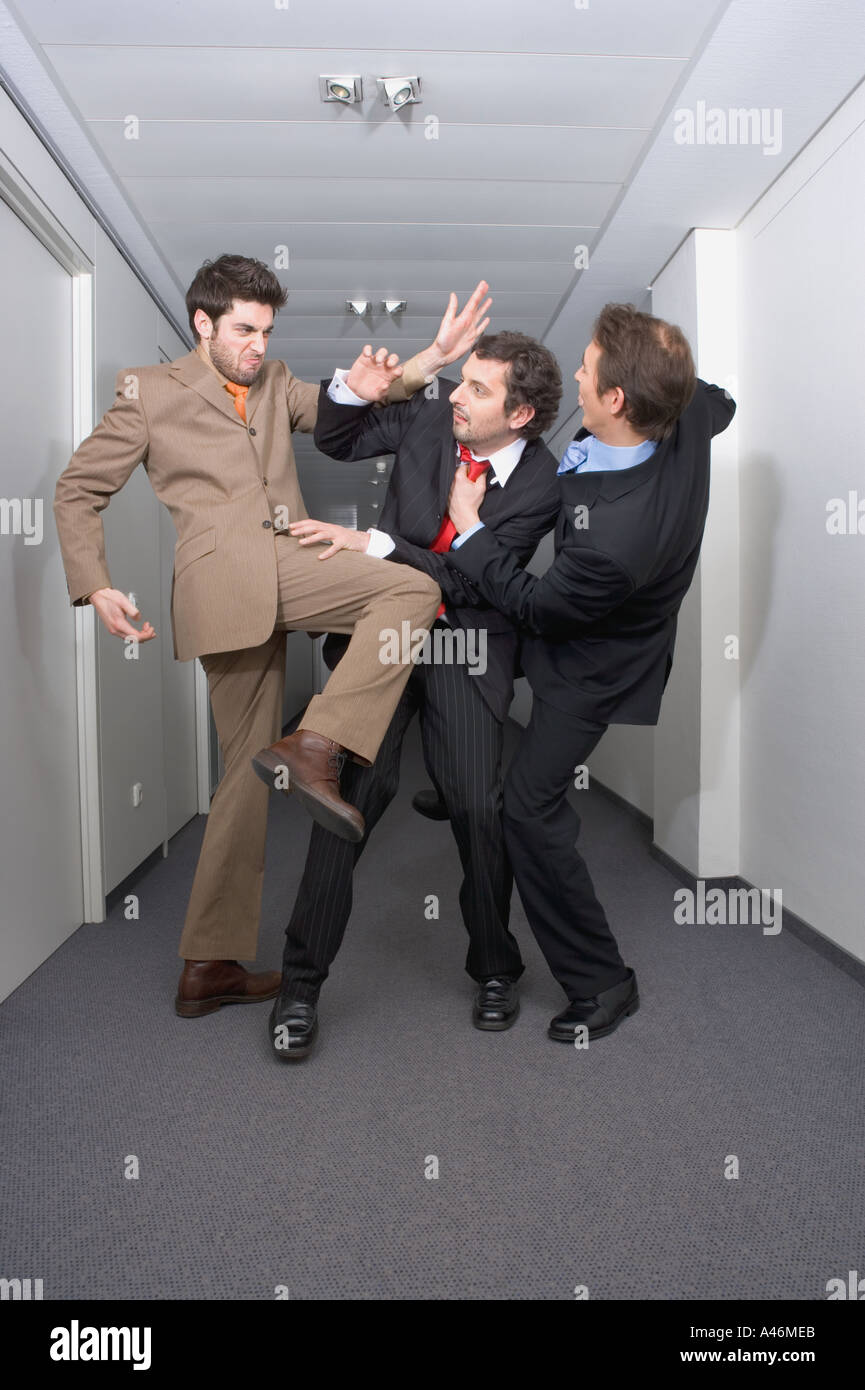 Three business people fighting hi-res stock photography and images - Alamy