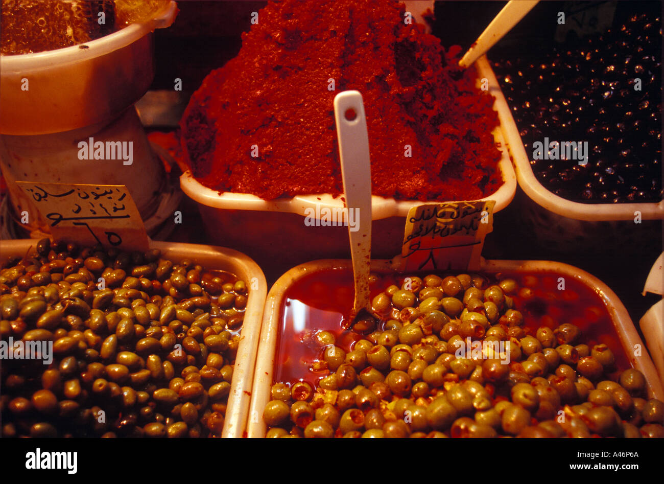 a selection of middle eastern foods olives honey and tomato paste in ...