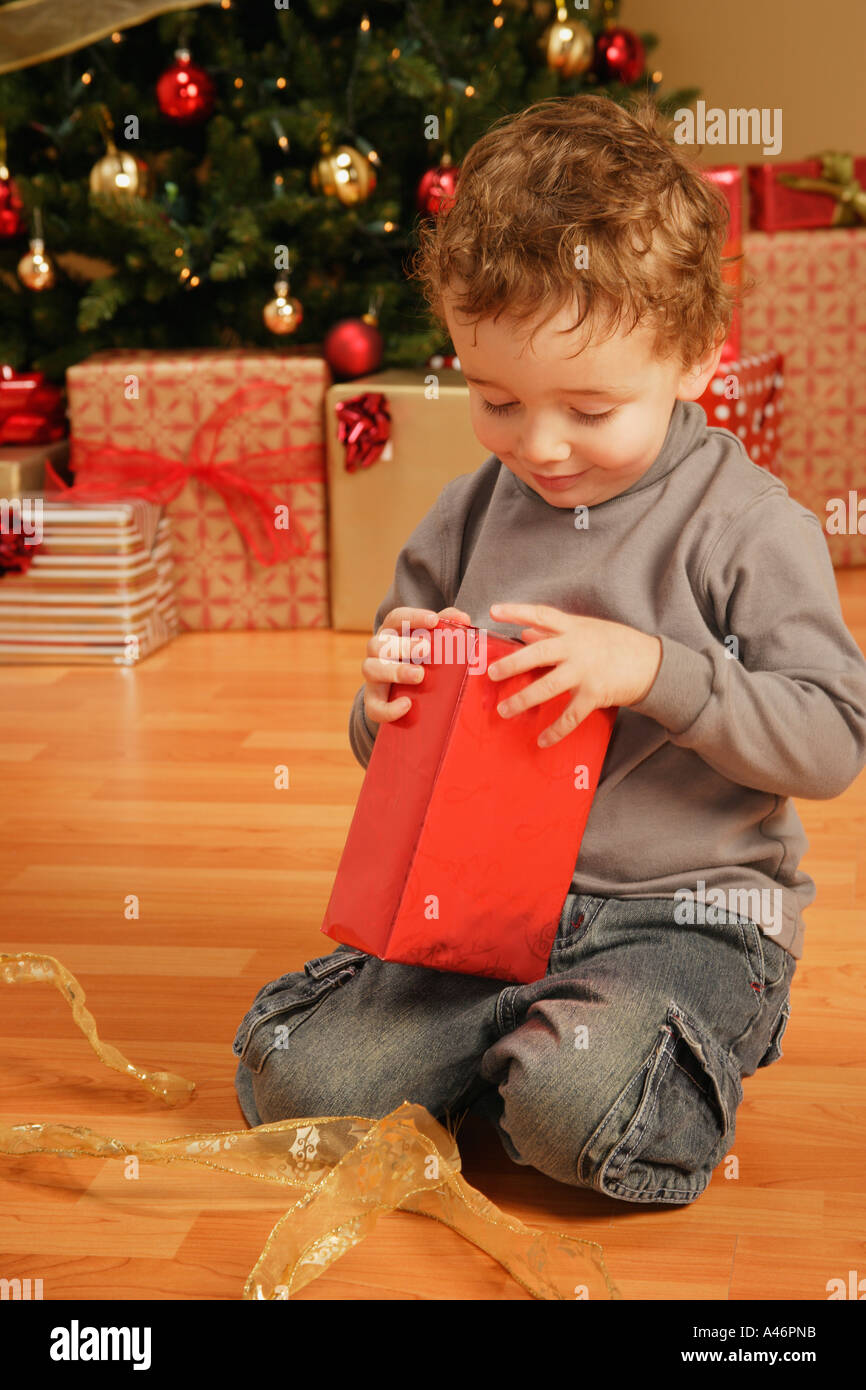 Child opens Christmas present Stock Photo - Alamy